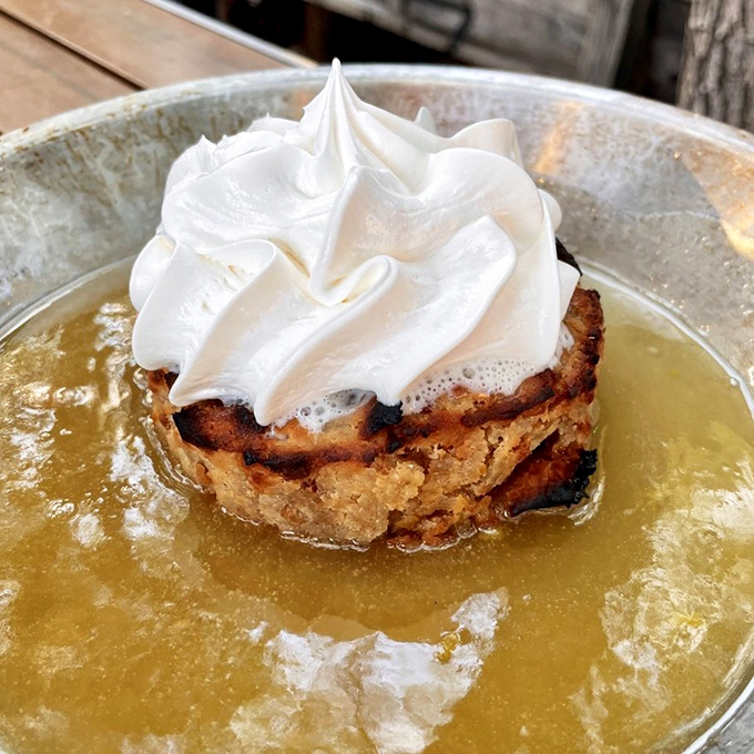 Bread pudding that makes you question all other desserts. That cloud of meringue floating on golden custard? Pure magic in a metal dish. 
