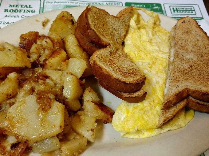 Home fries that achieve the perfect crisp-to-tender ratio alongside eggs that would make any chicken proudly cackle, "That's my work!"