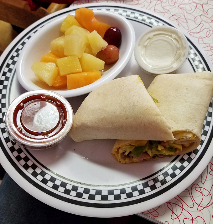 This breakfast wrap doesn't just talk the talk – it walks the walk with fresh ingredients, proper execution, and a side of fruit that almost makes you feel virtuous. Almost.