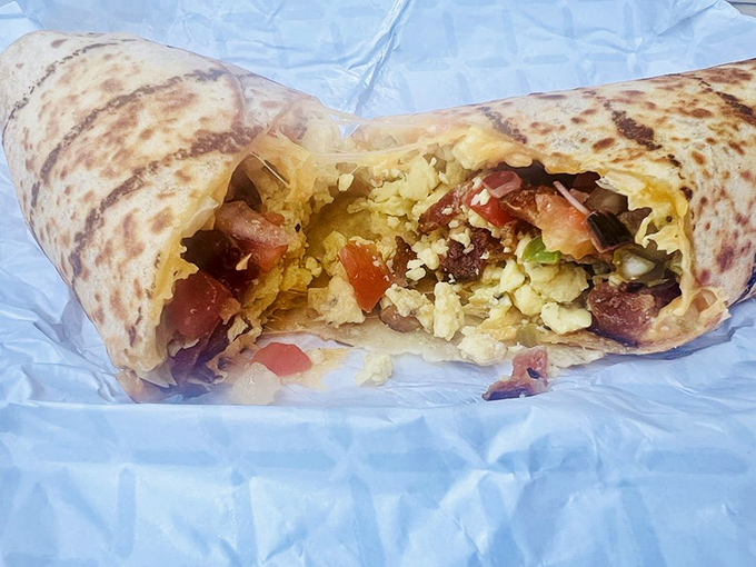 The breakfast burrito reveals its treasure trove of fresh ingredients, like a savory pi&ntilde;ata that's ready to party in your mouth.