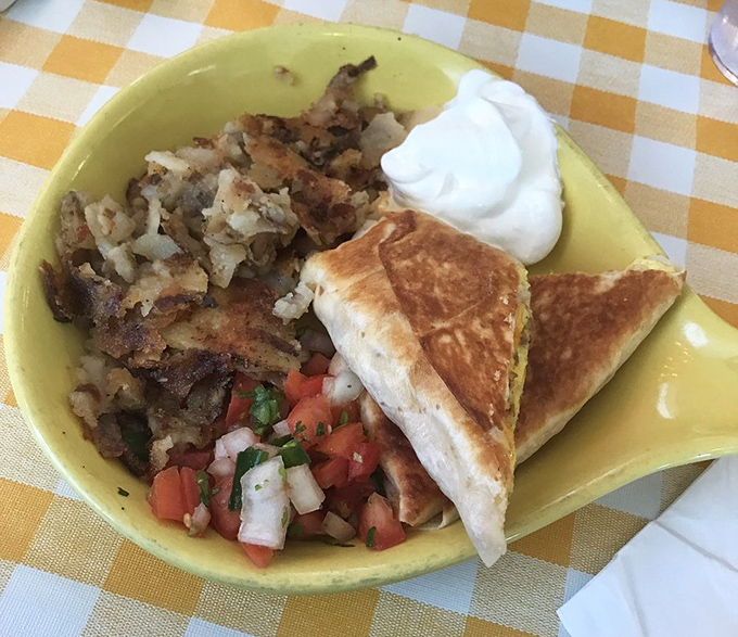 Breakfast that understands the assignment: crispy potatoes, fresh salsa, and a quesadilla that makes morning meetings almost bearable.