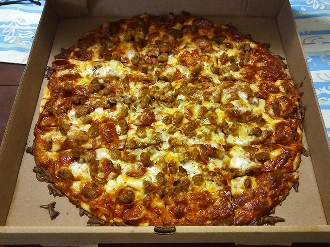 This pizza doesn't just have toppings&mdash;it has ambition! Sausage and cheese melted to golden perfection, waiting to make your day better.