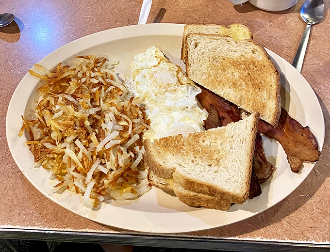 This isn't just breakfast&mdash;it's morning salvation on a plate. Crispy hash browns, perfectly toasted bread, and eggs that would make a chicken proud.