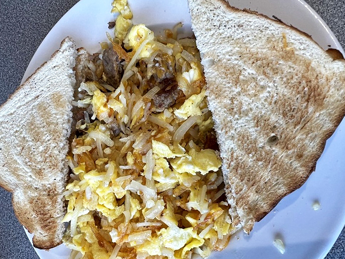 Breakfast hash that means business&mdash;eggs, potatoes, and meat dancing together in perfect morning harmony on toasted bread.