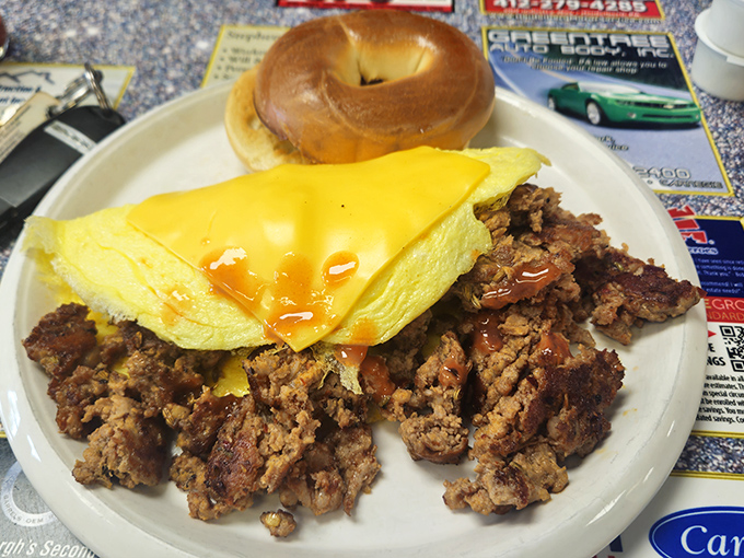 When breakfast demands more than cereal, this hearty plate answers the call &ndash; perfectly folded eggs, savory sausage, and a bagel that means business.