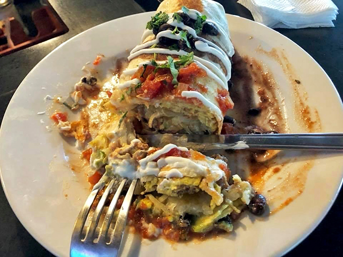 Not just a burrito, but a architectural marvel of flavor - layers of goodness waiting to be excavated with each bite. Fork required, patience rewarded.