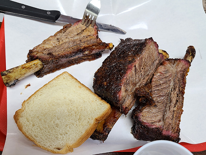 Brisket slices with that telltale smoke ring, accompanied by the traditional white bread that serves as Texas barbecue's most elegant utensil.