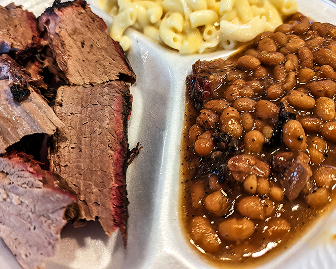 Brisket so tender it surrenders at first sight, paired with beans that have clearly been taking flavor lessons from their meaty neighbors.