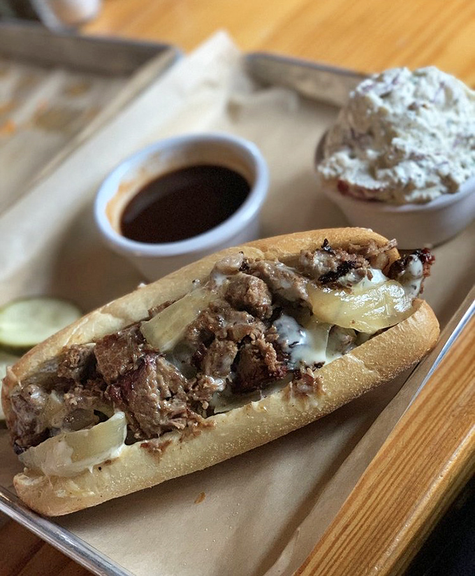 The Brisket Dipwich: where tender smoked beef meets melted cheese and grilled onions. Add the au jus, and you've got a sandwich worth crossing county lines for.