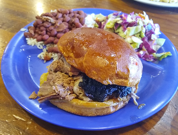 This isn't just a sandwich; it's an architectural marvel of smoked meat, sauce, and bread that requires both hands and several napkins.