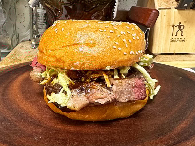 This isn't just a sandwich; it's an architectural marvel of smoked meat, crisp slaw, and pillowy bun that requires both hands and your full attention.