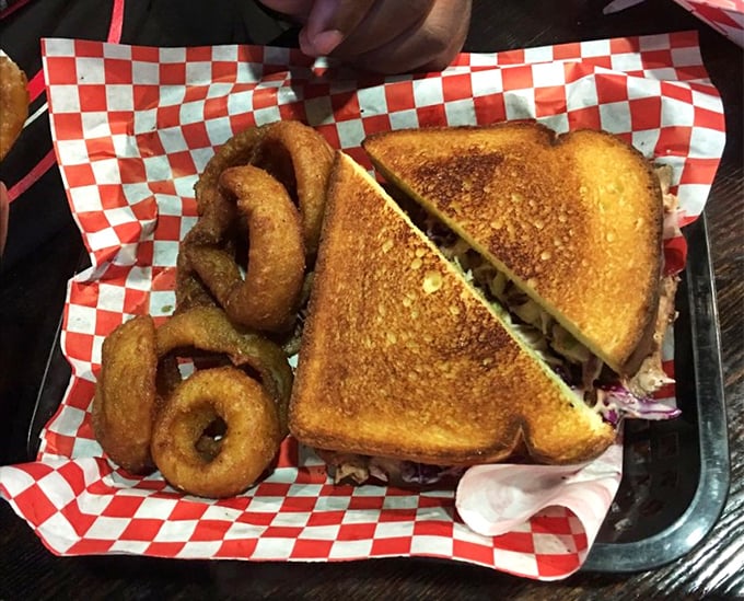 The sandwich that launched a thousand napkins. Golden-toasted bread, perfectly fried onion rings, and a story of smoke and patience between the slices.