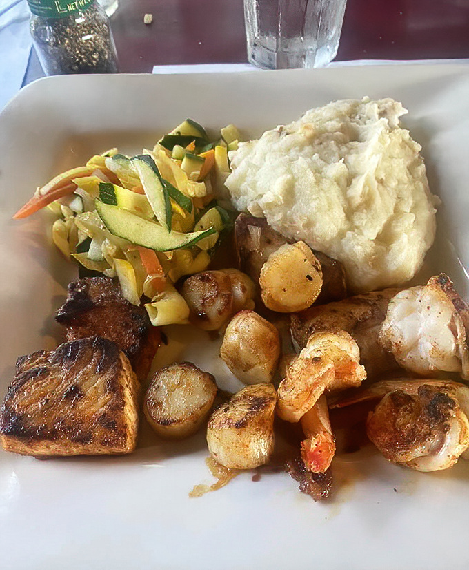 A seafood platter that would make Neptune jealous&mdash;perfectly seared fish, plump scallops, and succulent shrimp alongside homestyle sides.
