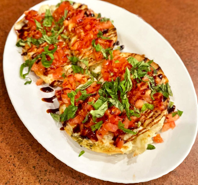 The bruschetta arrives like edible artwork&mdash;vibrant tomatoes, fresh herbs, and a balsamic drizzle that makes you wonder why you ever settled for lesser versions.