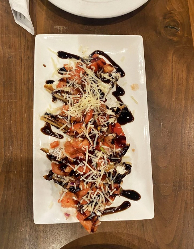 This bruschetta isn't just a starter—it's an edible work of art. Fresh tomatoes, balsamic drizzle, and a shower of Parmesan that makes you want to applaud.