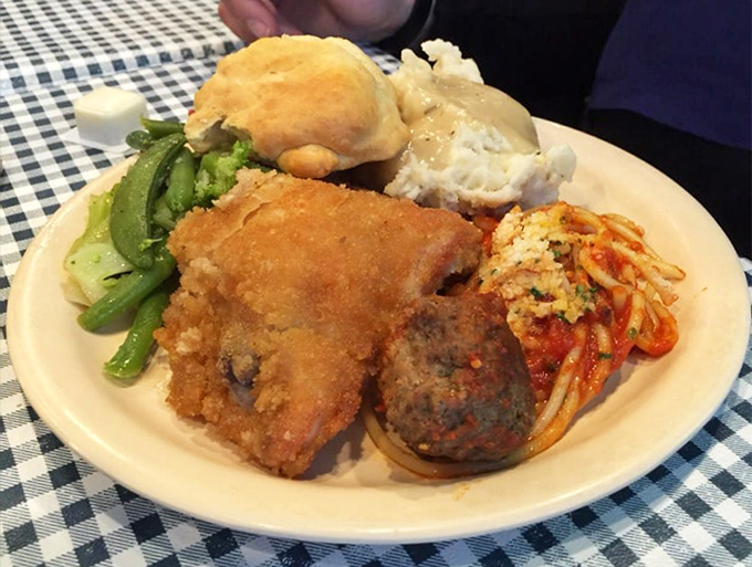 A plate that says "I'm on vacation from my diet." Meatballs, pasta, and fried chicken create the holy trinity of comfort food.