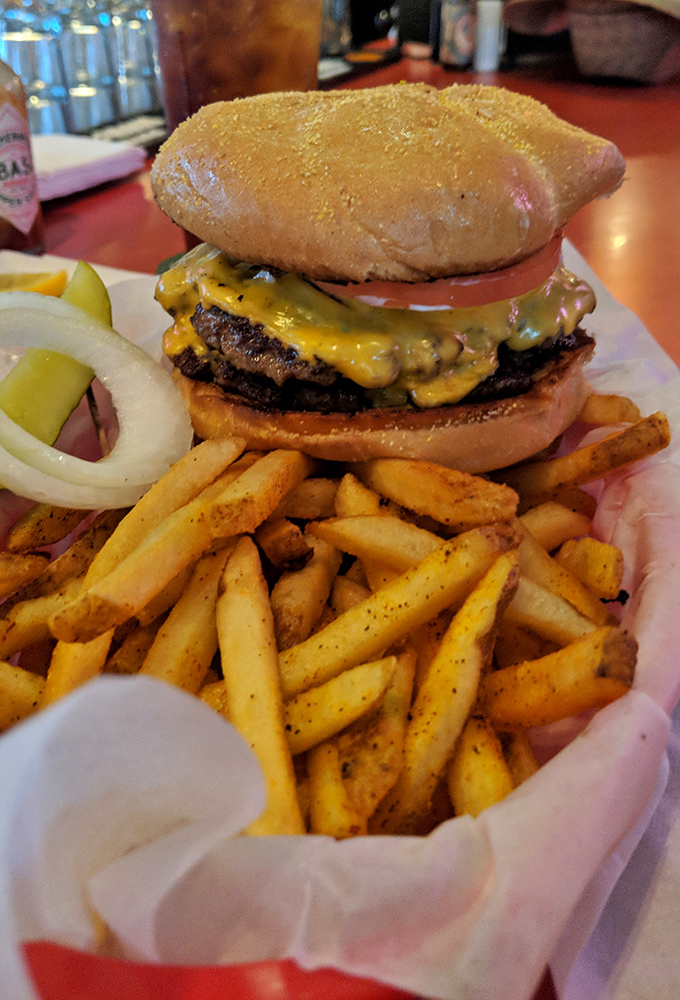 This isn't just a burger; it's edible architecture &ndash; a towering masterpiece of beef, cheese, and fresh toppings that demands both hands and your full attention.