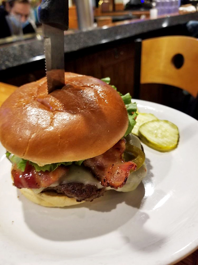 This isn't some dainty, tweezered gastropub creation—it's an honest-to-goodness burger with all the fixings that requires both hands and zero pretension.