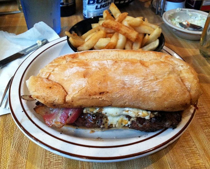 Behold the sandwich that launched a thousand road trips. This burger, nestled in a crusty roll with melty cheese, demands both hands and your full attention.