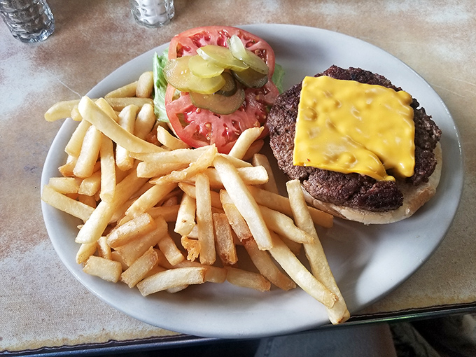 The classic American burger, dressed for success with melty cheese and a garden of toppings, flanked by an army of golden fries.