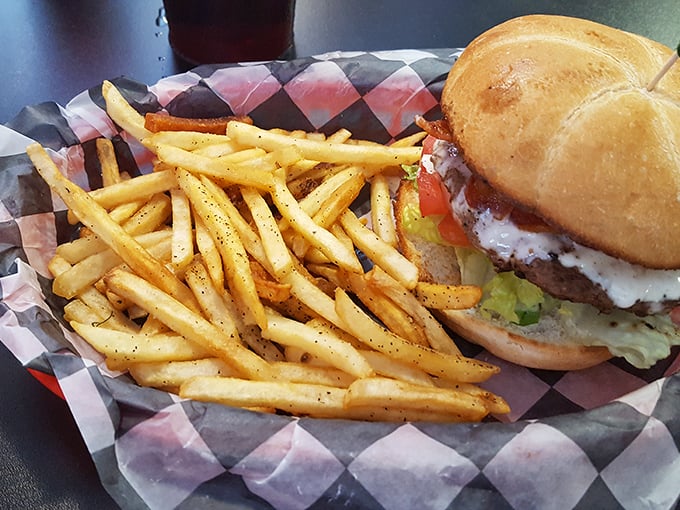 A burger that requires a strategy session before the first bite, paired with fries that achieve that mythical balance between crispy exterior and fluffy interior.