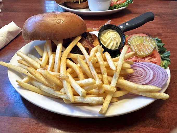 A burger that demands a two-handed commitment, with fries that achieve that perfect balance between crisp exterior and fluffy interior.