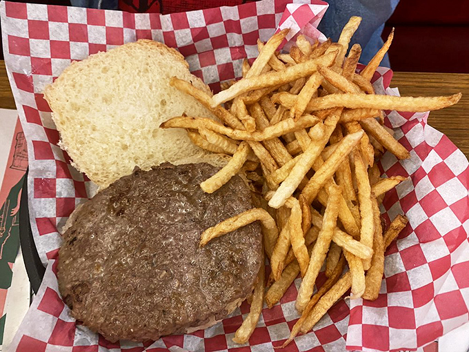 The burger arrives on classic red-checkered paper&mdash;a juicy masterpiece with golden fries that would make fast food chains weep with inadequacy.
