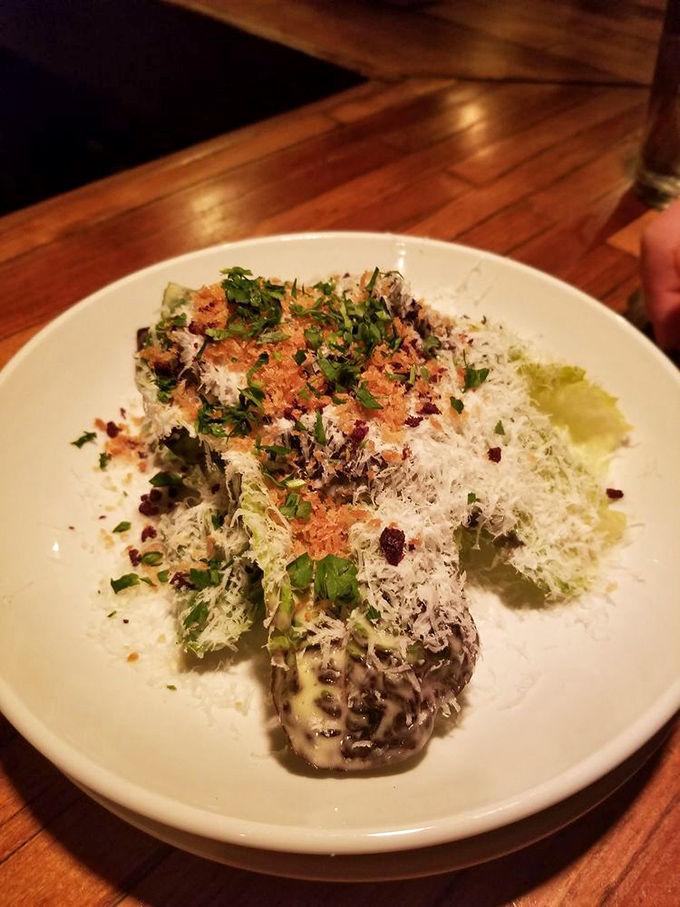 This Caesar salad isn't just dressed—it's wearing its Sunday best with a snowfall of cheese and breadcrumbs that would make any romaine feel special.