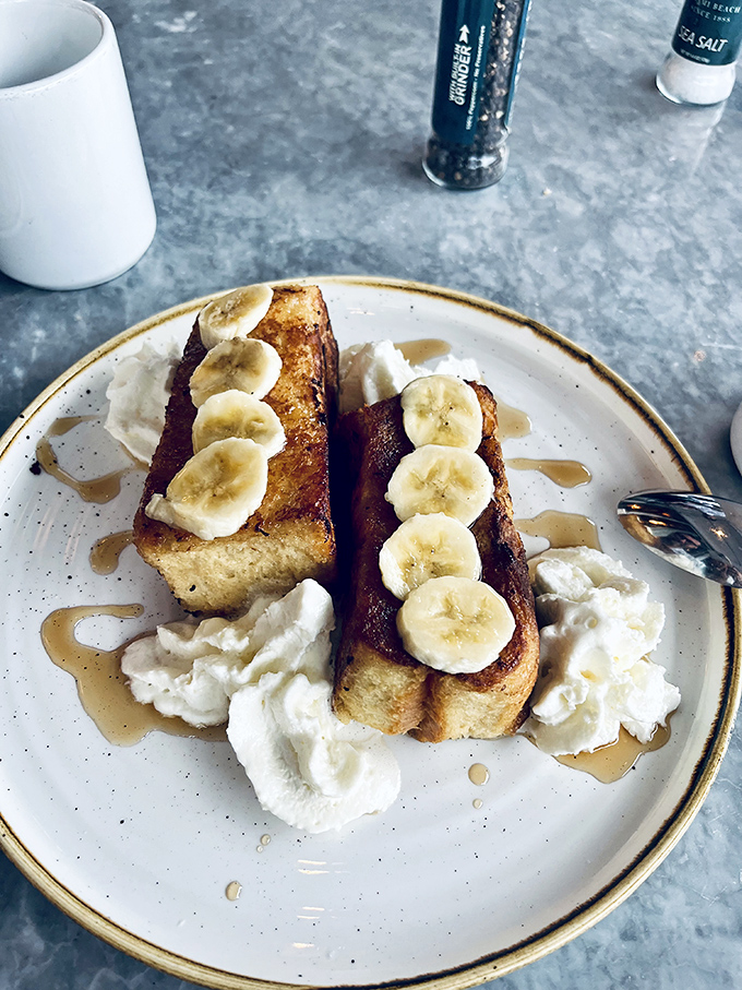 French toast that makes you question all other breakfast decisions. Those bananas aren't just garnish—they're co-stars in this morning masterpiece.