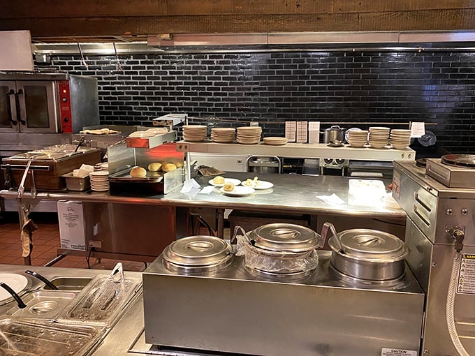 Behind the scenes in York's kitchen, where stainless steel workstations and black subway tile create the backstage magic that transforms simple ingredients into memorable meals.