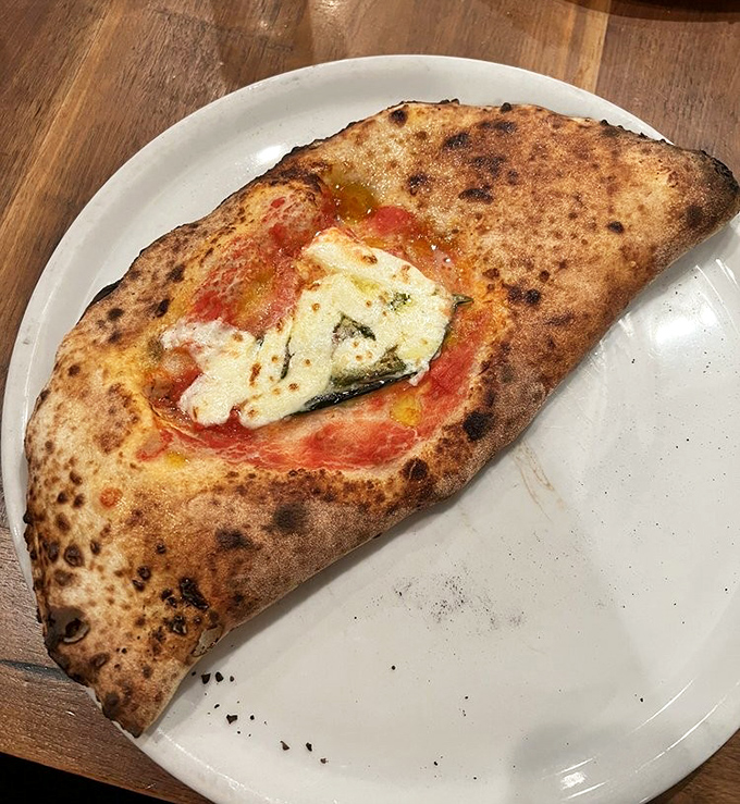 The calzone &ndash; pizza's mysterious, folded cousin that somehow manages to pack even more flavor into each heavenly bite.