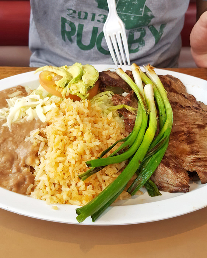 Carne asada done right is poetry on a plate. The green onions aren't just garnish&mdash;they're the exclamation point on a meaty masterpiece.