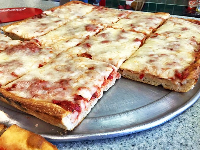 The Sicilian square pie that launched a thousand cravings. Thick, pillowy crust topped with a blanket of melted cheese that stretches for days.