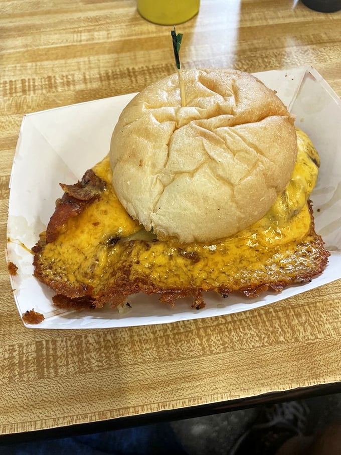 The famous cheese skirt in all its glory. Like a solar flare of cheddar, it extends gloriously beyond the bun, creating the perfect crispy-gooey contrast.