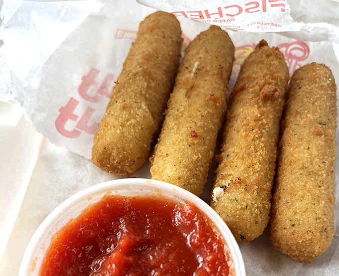 Golden-fried mozzarella sticks&mdash;crunchy armor protecting molten cheese treasure within. The marinara dipping sauce is just the sidekick they deserve.