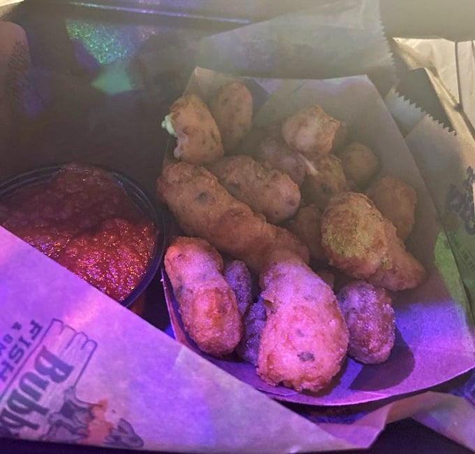 Golden cheese curds arrive like little nuggets of dairy heaven, crispy outside and melty within.