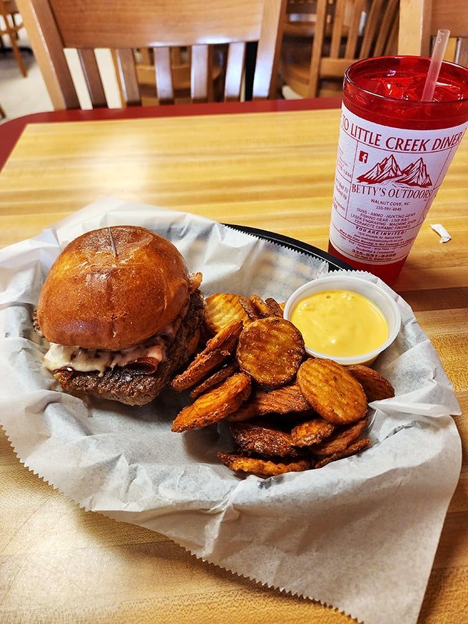 This isn't just a burger&mdash;it's edible architecture. A golden-brown bun cradling a hand-formed patty with melty cheese and those house-made chips? Pure comfort engineering.