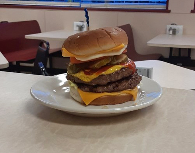 This isn't just a burger&mdash;it's a skyscraper of beef that requires jaw exercises before attempting. Structural engineering meets comfort food in the most delicious way possible.