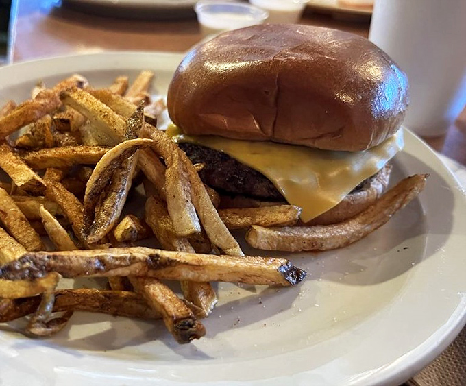 The classic American cheeseburger and hand-cut fries&mdash;proof that sometimes the simplest pleasures are the most profound culinary statements.
