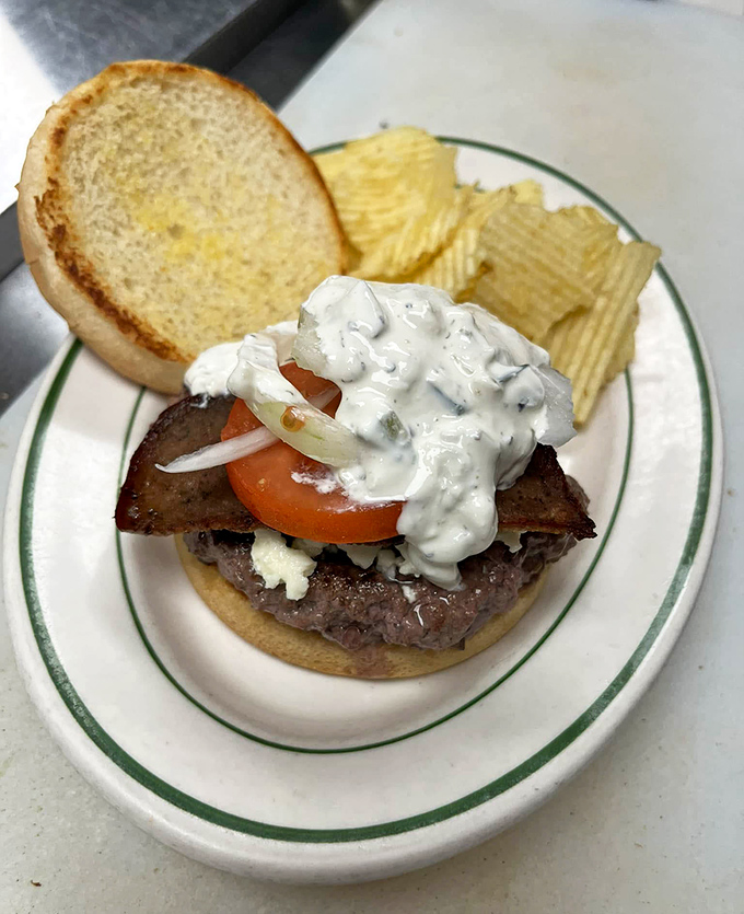 This isn't some fancy gastropub creation&mdash;it's a proper diner burger with all the fixings and zero pretension. The cream sauce adds that special touch.