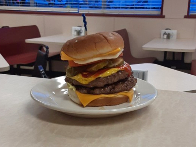 This isn't just a burger; it's a skyscraper of beef that requires both strategic planning and jaw exercises before attempting.