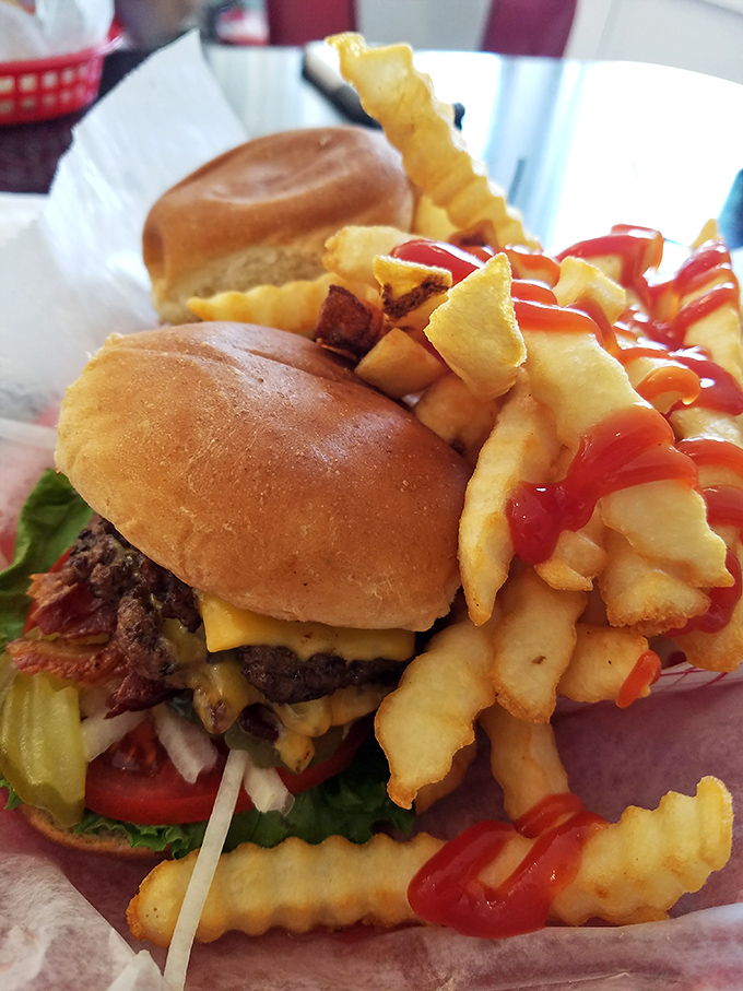 Behold the cheeseburger in its natural habitat&mdash;perfectly charred patty, melted cheese, fresh toppings, and those golden fries standing at attention.