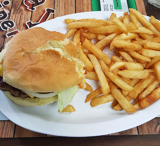 The classic American diner equation: one perfectly grilled cheeseburger + golden fries = happiness on a plate that would make any cardiologist nervously fidget.
