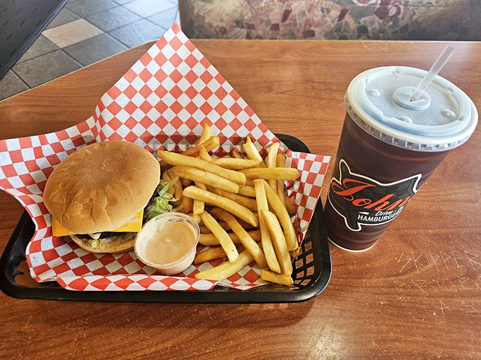 The holy trinity of burger bliss: a perfectly charred patty, golden fries, and a shake that requires both straw and spoon diplomacy.