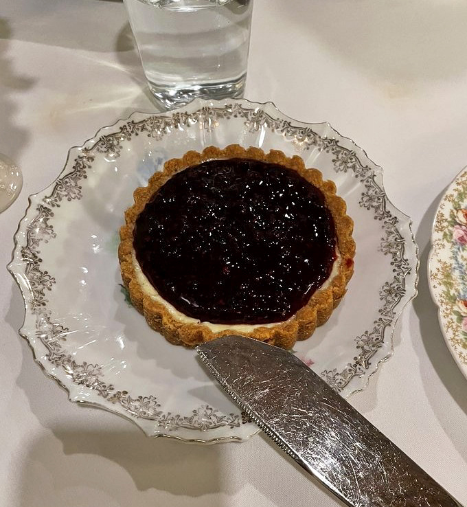 Cheesecake tart perfection on vintage china &ndash; the kind of dessert that makes conversation stop and eyes close in silent appreciation.