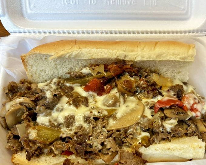 The Deluxe Cheesesteak: where Pennsylvania traditions meet barbecue expertise. Those peppers and mushrooms aren't just toppings&mdash;they're supporting actors in a meaty masterpiece.