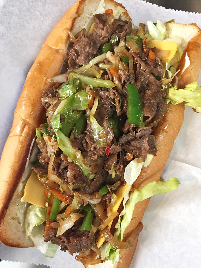 Behold the cheesesteak in its natural glory&mdash;overflowing with meat, veggies, and melty cheese. This isn't a sandwich; it's an architectural marvel.