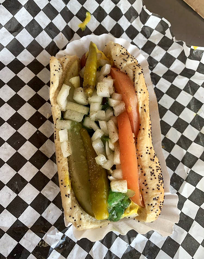 The Chicago dog in its natural habitat &ndash; poppy seed bun, vibrant toppings, and the cardinal rule: absolutely no ketchup allowed.