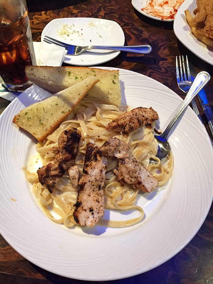 Pasta that doesn't swim with the fishes, but alongside them. Grilled chicken fettuccine alfredo provides a delicious break from seafood overload.