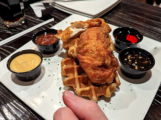 Chicken and waffles: where breakfast and dinner stopped fighting and fell in love. Four dipping sauces because sometimes monogamy is overrated when it comes to condiments.